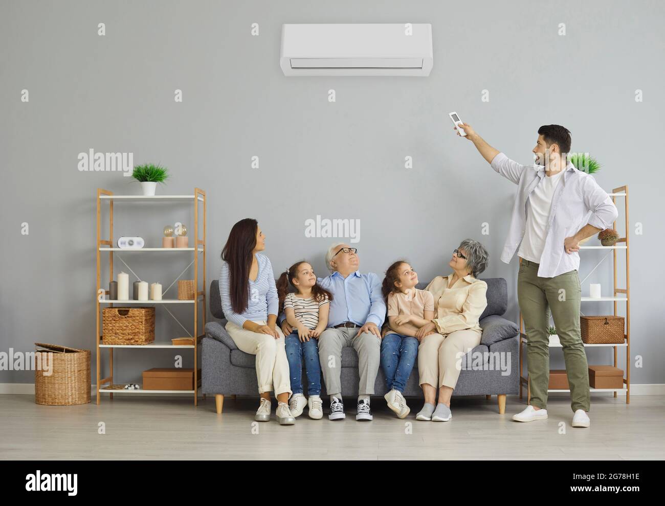 Man holding a remote control air conditioner makes a comfortable ...