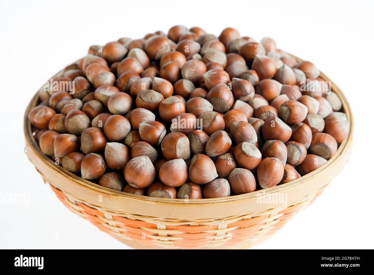 Hazelnut in bowl isolated on white background Stock Photo - Alamy