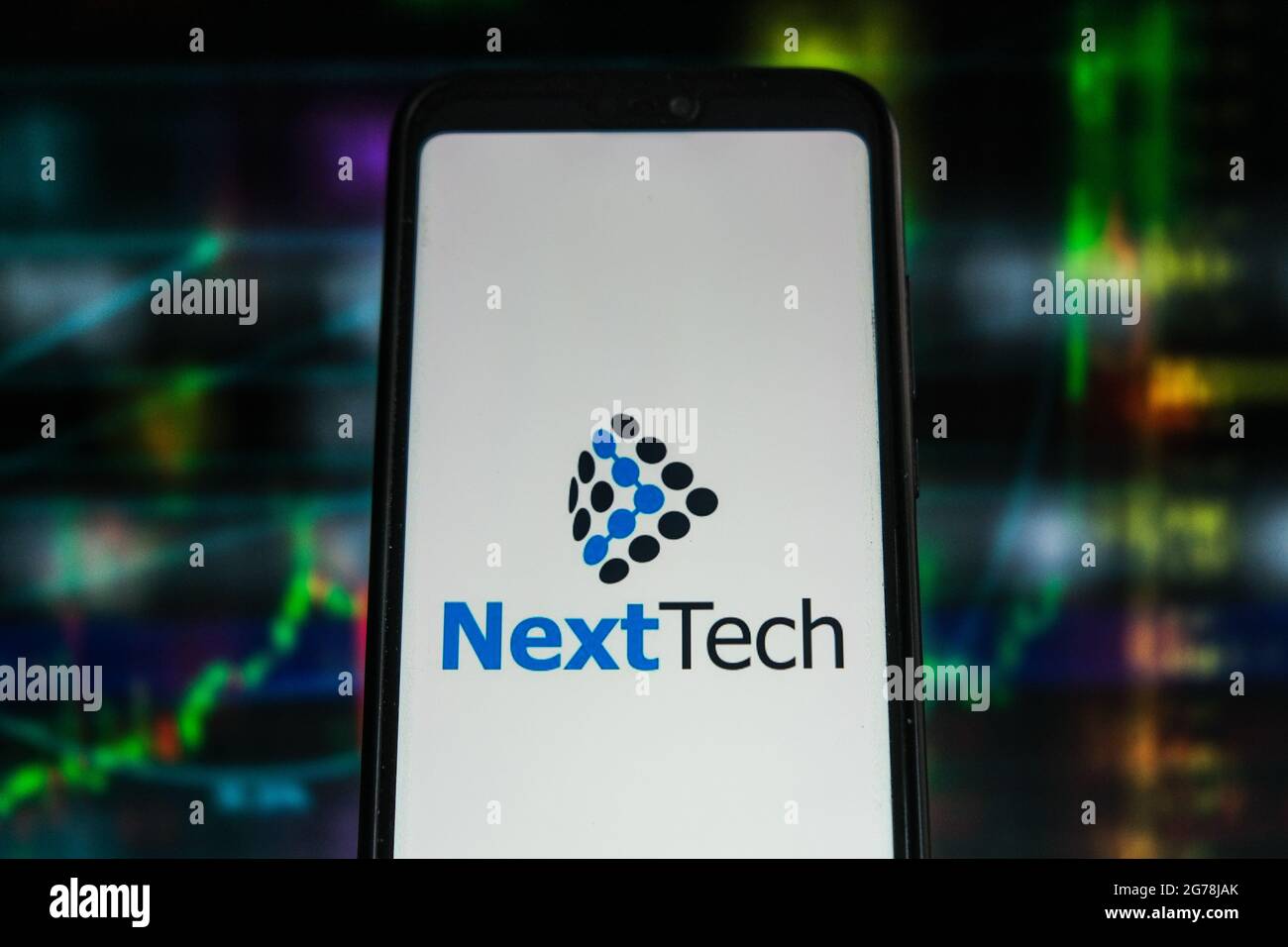 In this photo illustration a NextTech logo seen displayed on a smartphone with stock market ...