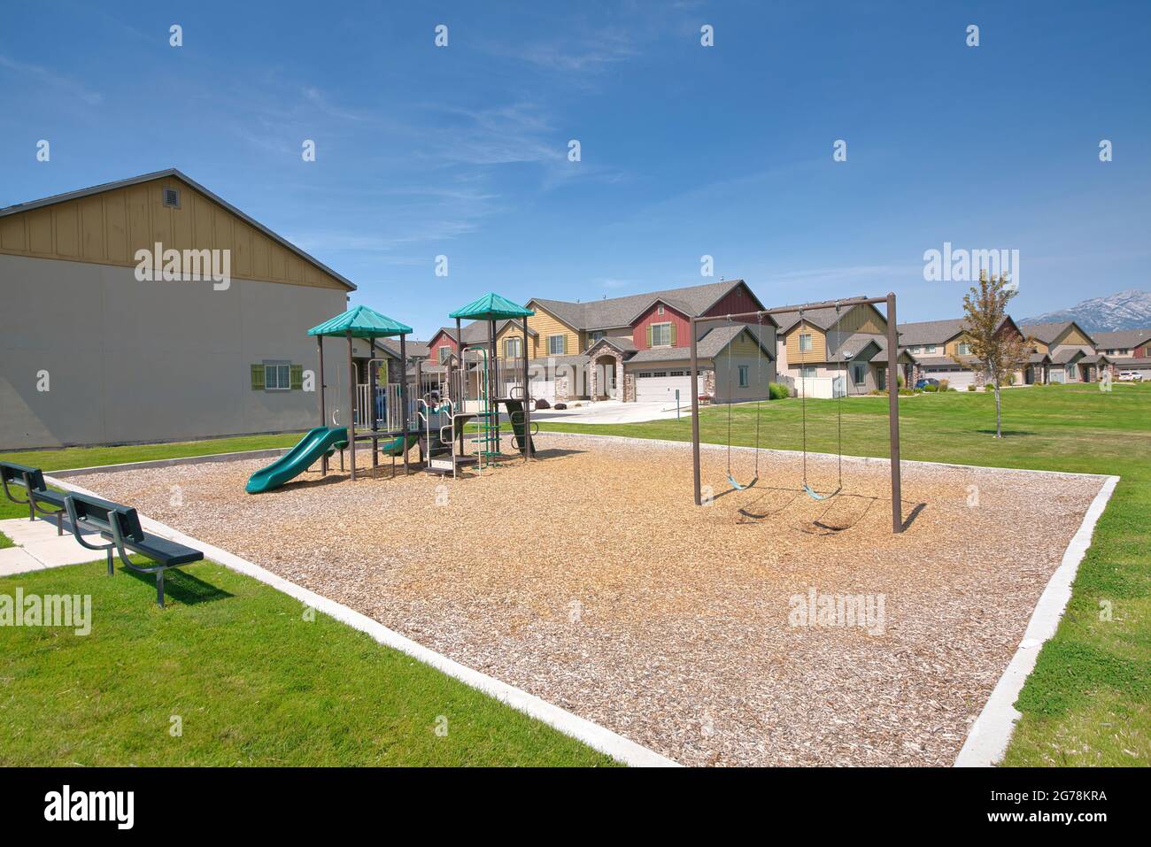 Community playground with slides swings and benches for children and ...