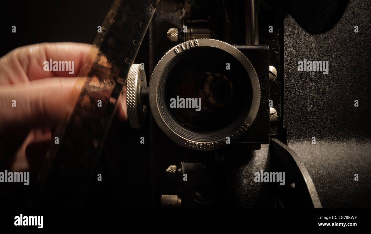 Inserting the film into an old film projector macro shot hi-res stock ...