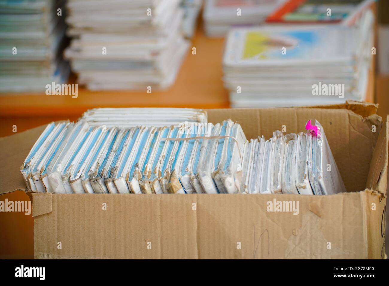 Old battered books in a paper box for putting in waste paper Stock ...
