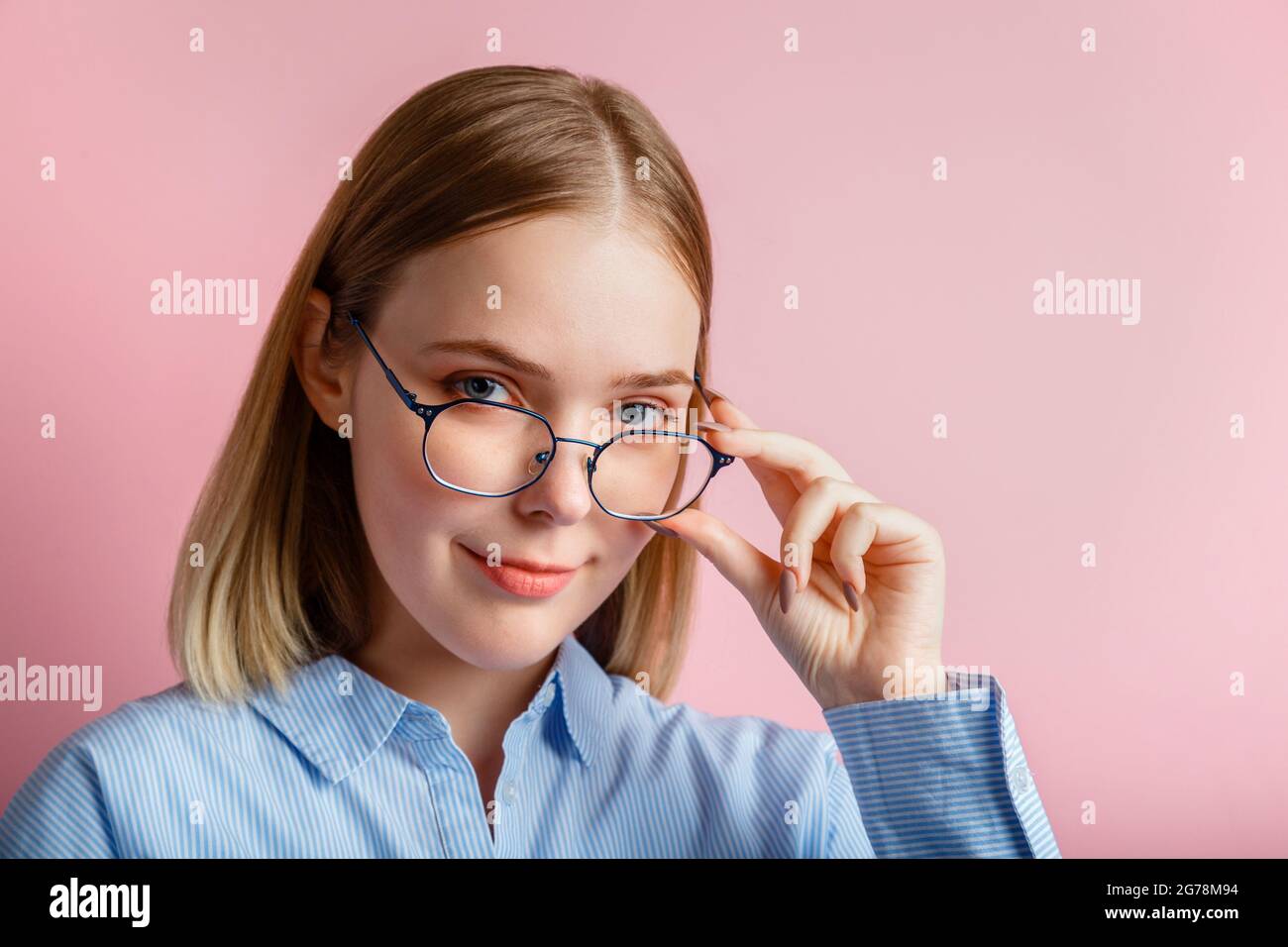 Portrait of confident successful young woman in glasses. Office worker ...
