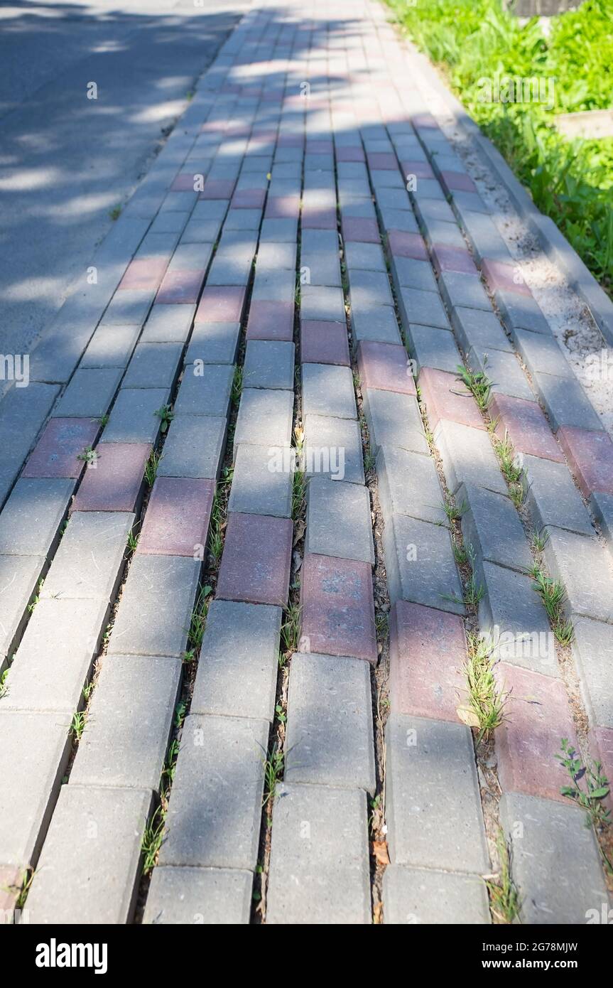 Pavement paved with stone, with defect. Poorly made pedestrian road, in ...