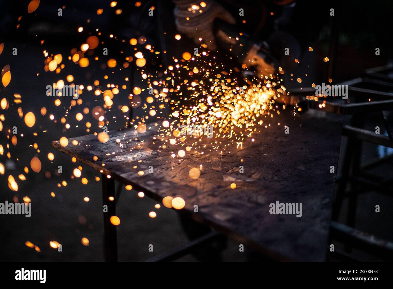 Metal processing in the workshop. Grinding metal. The worker makes the ...