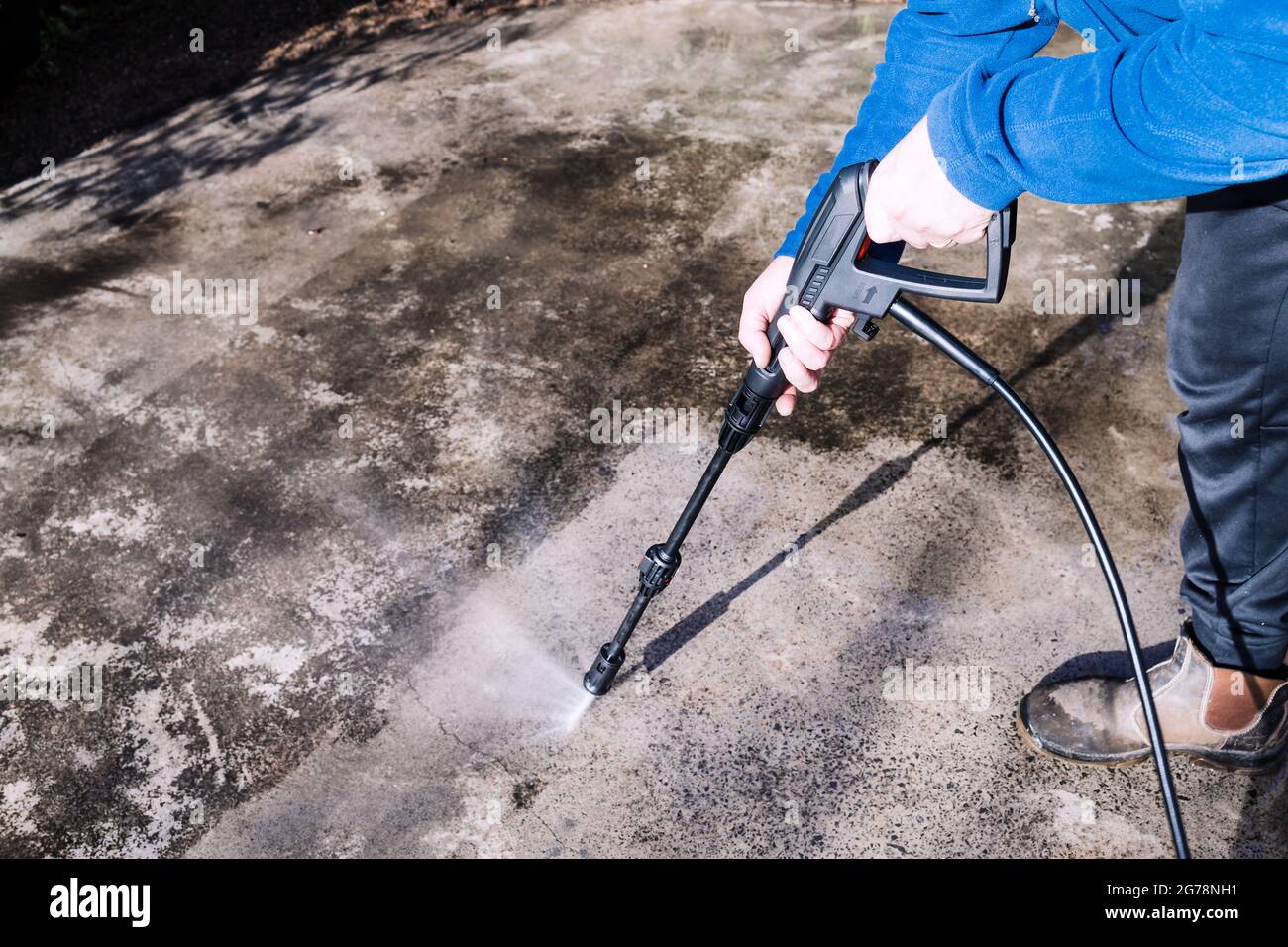 high pressure washer cleaning backyard or driveway concrete paving ...