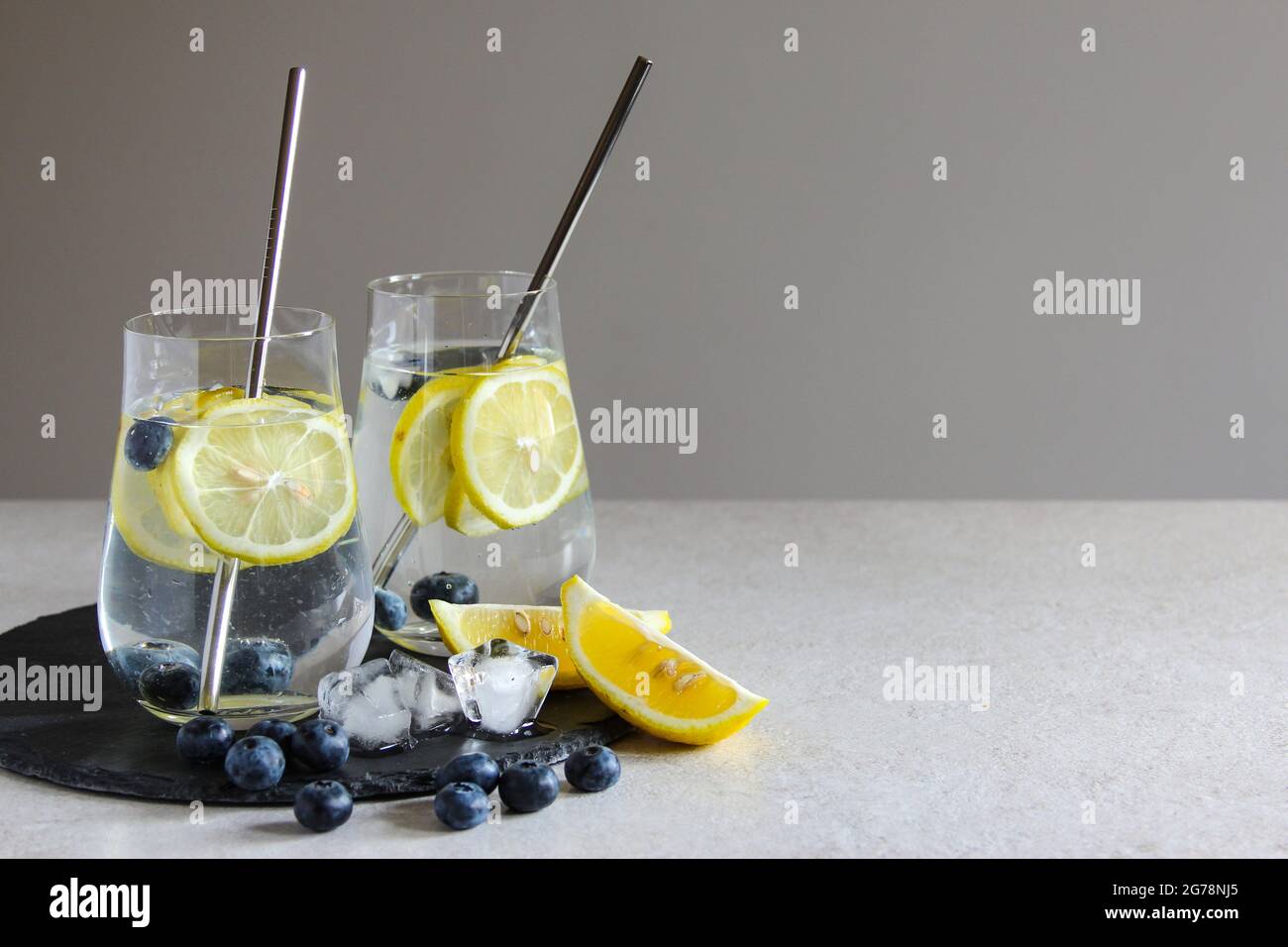 Cold drinks in small bottles. Cherries and lemon lemonade or cocktail ...