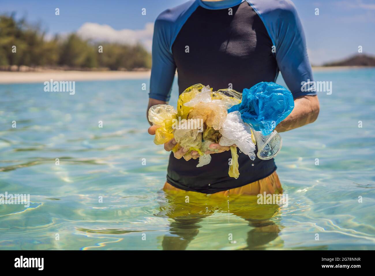 Man collects packages from the beautiful turquoise sea. Paradise beach ...