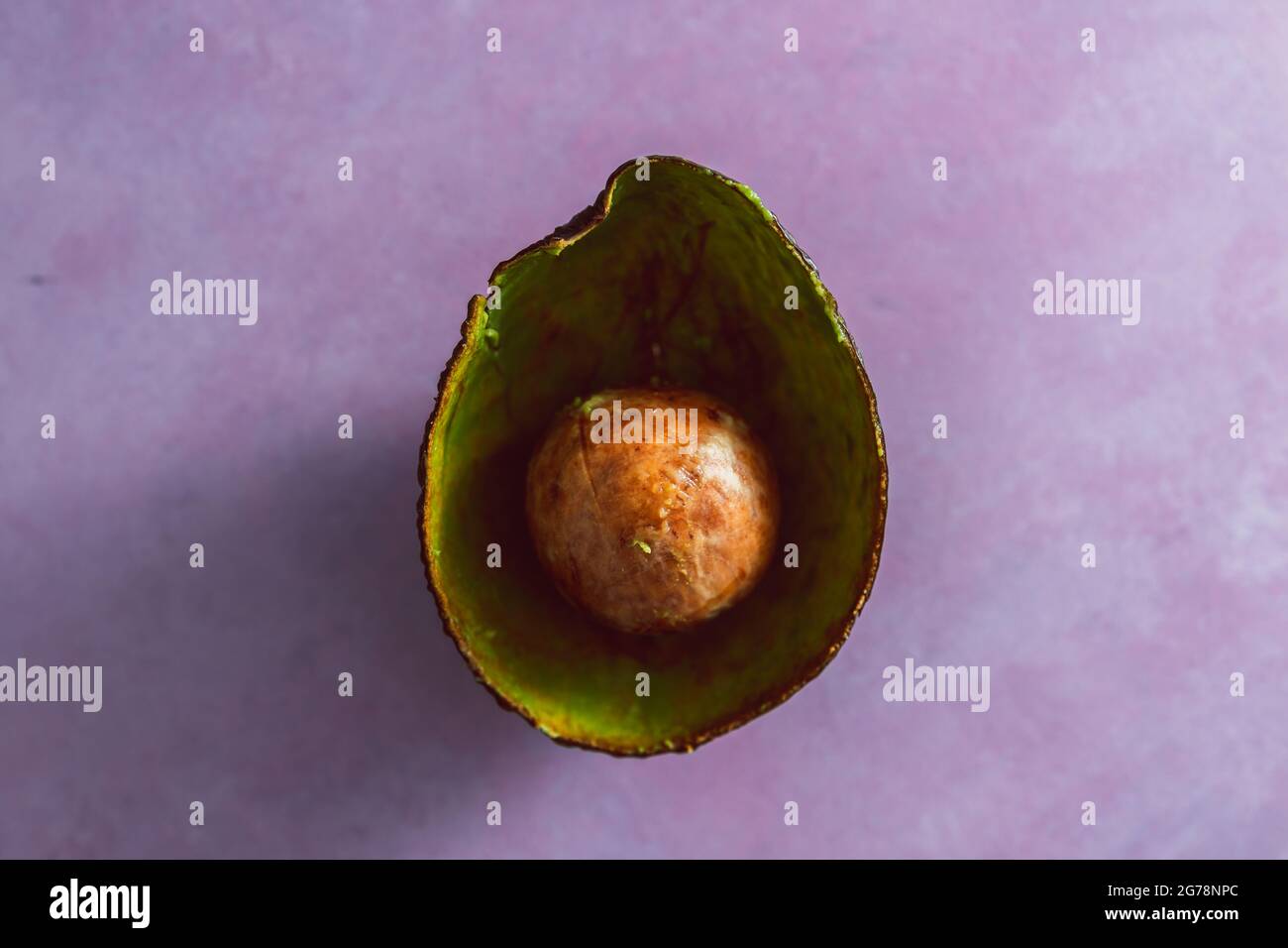 half empty avocado with pulp removed and only pip and skin remaining ...