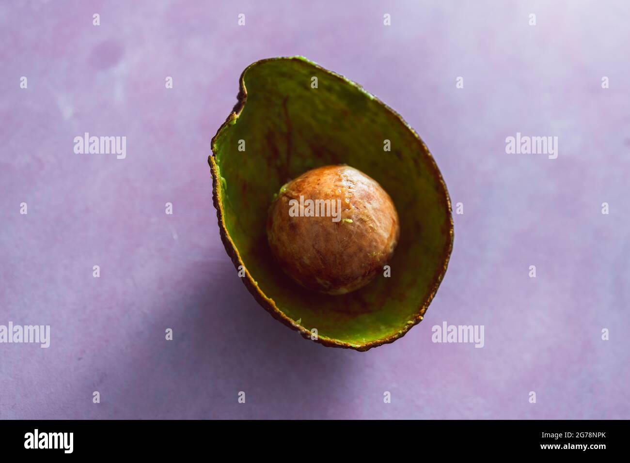 half empty avocado with pulp removed and only pip and skin remaining ...