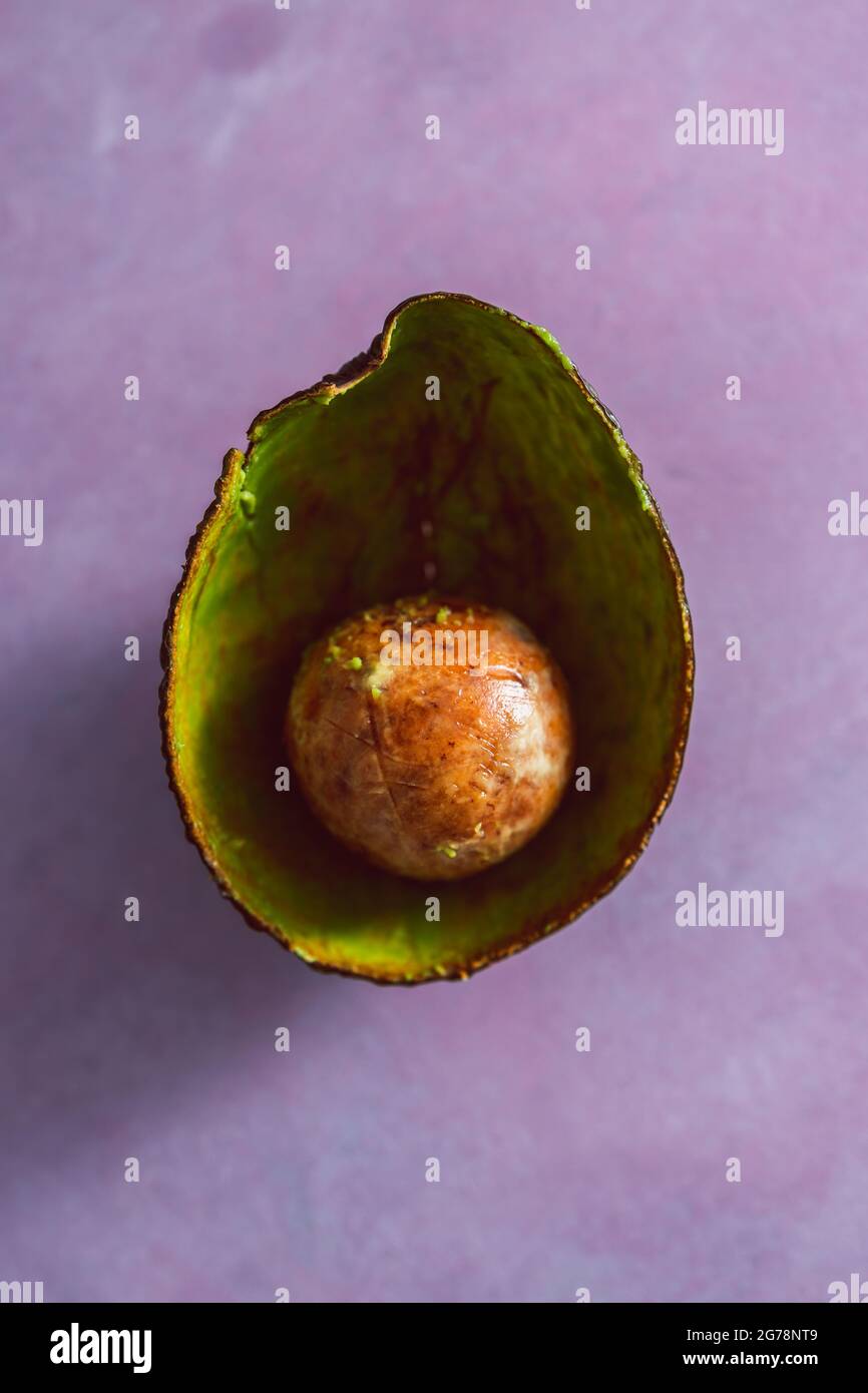 half empty avocado with pulp removed and only pip and skin remaining ...