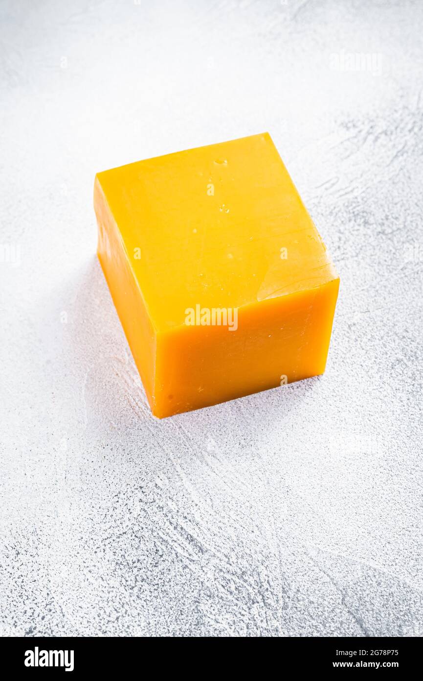 Cheddar Cheese block on a kitchen table. White background. Top view ...