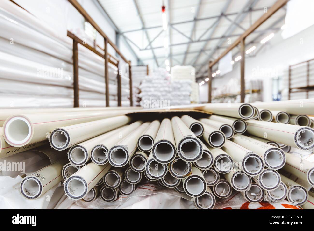 Warehouse of polypropylene pipes. Workshop with extruders for producing ...