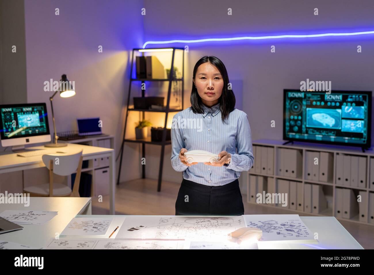 Portrait of serious young Asian female automotive exterior designer ...