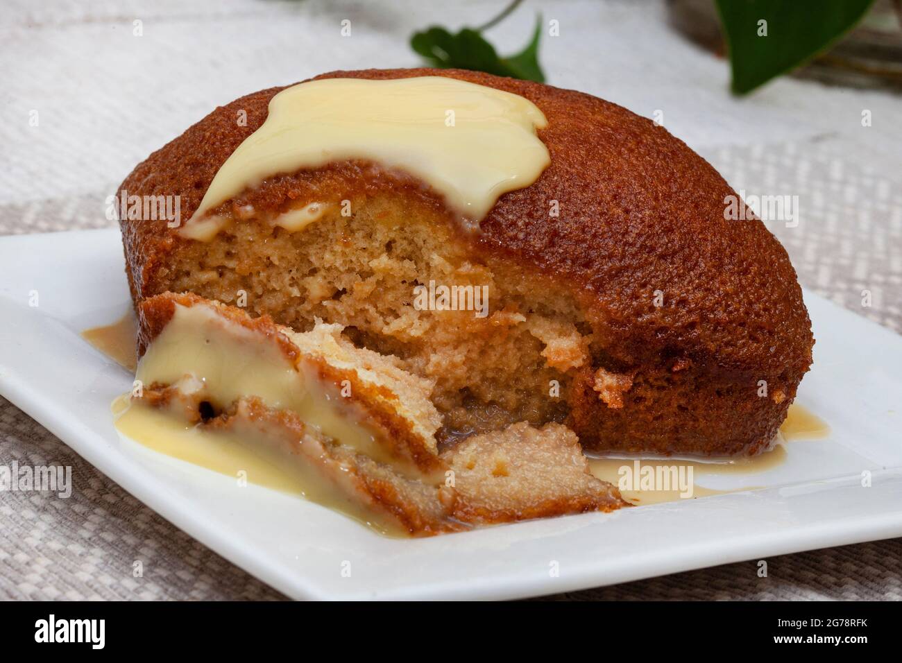 traditional South African Malva pudding served with custard Stock Photo ...