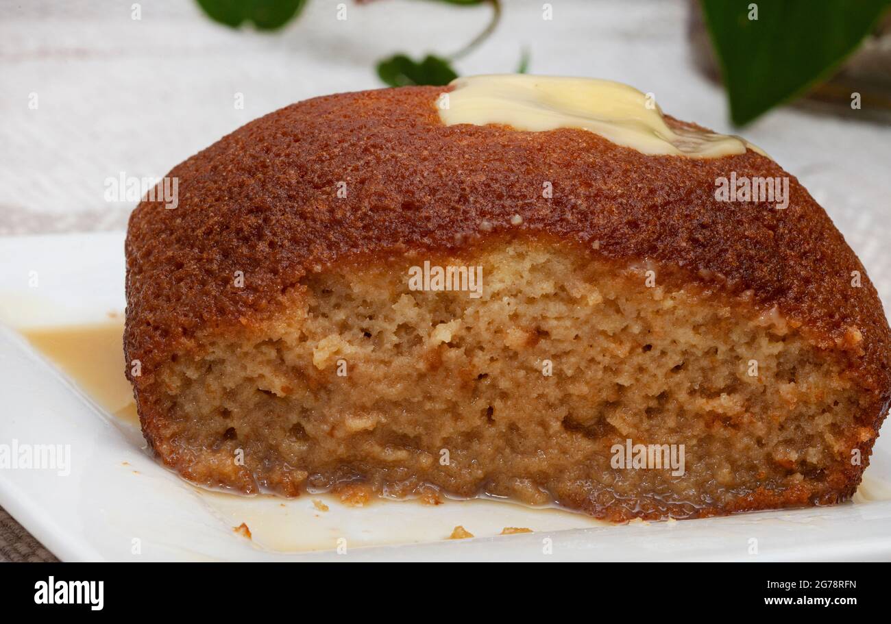 traditional South African Malva pudding served with custard Stock Photo ...