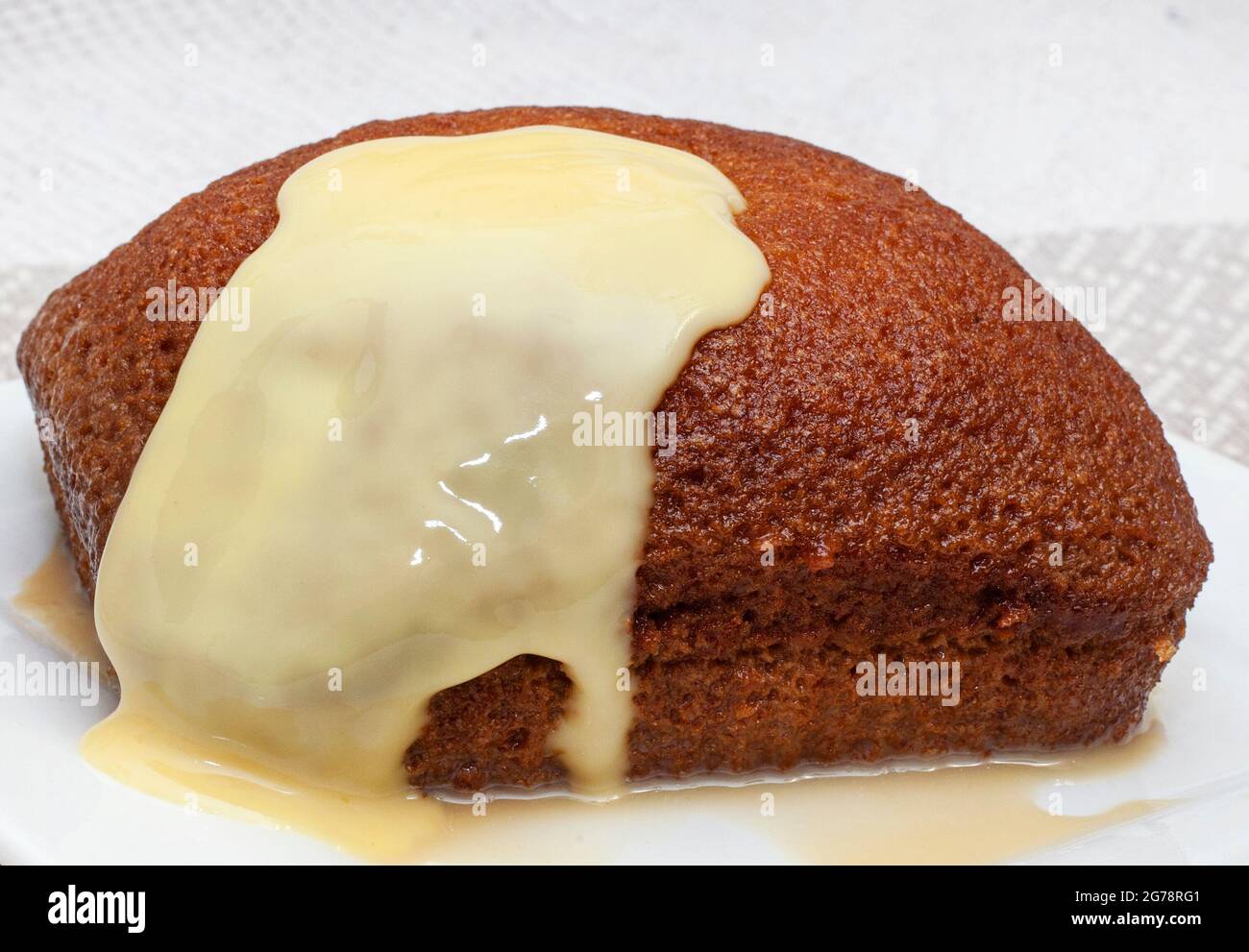 traditional South African Malva pudding served with custard Stock Photo ...