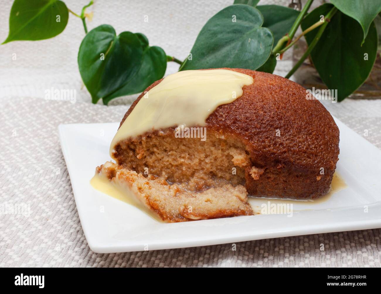 traditional South African Malva pudding served with custard Stock Photo ...