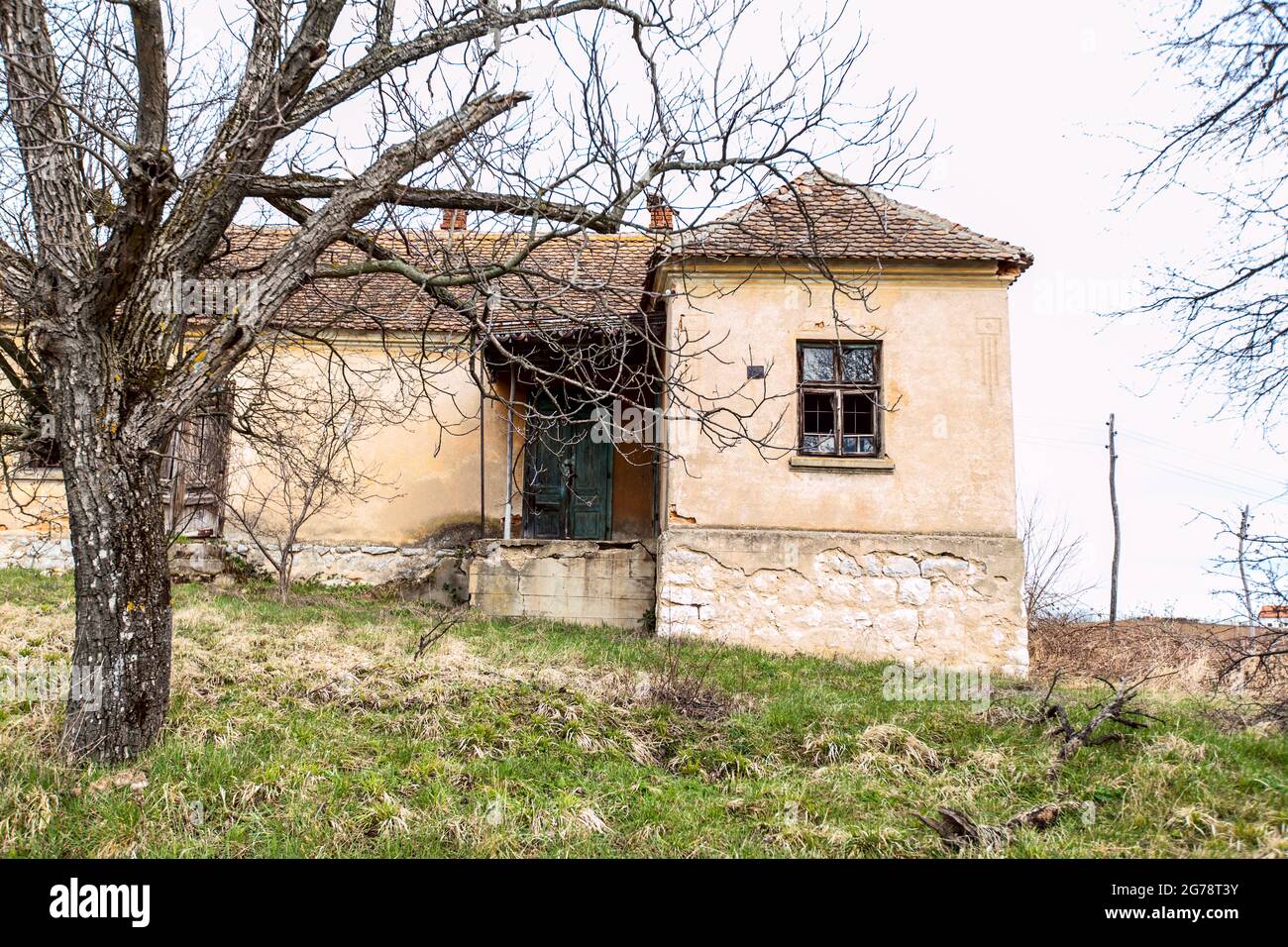 Deserted, weathered house in a rural landscape stands as a reminder of ...