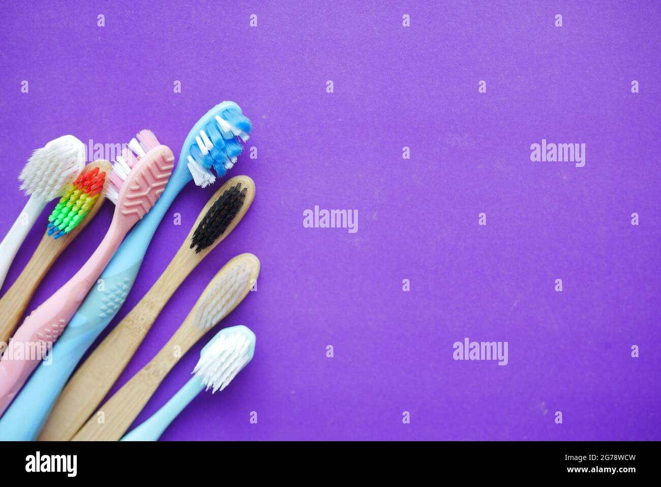 colorful toothbrushes on purple background Stock Photo - Alamy