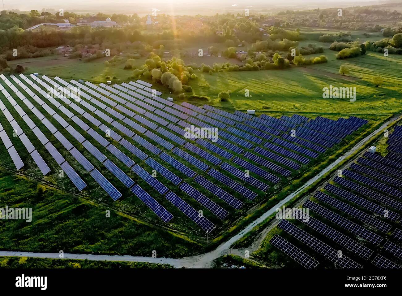 Ecology solar power station panels in the fields green energy at sunset ...