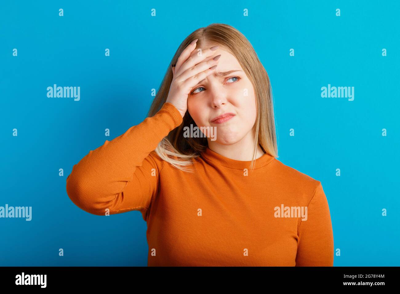 Young woman experiencing stress headache holding her head. Emotional ...