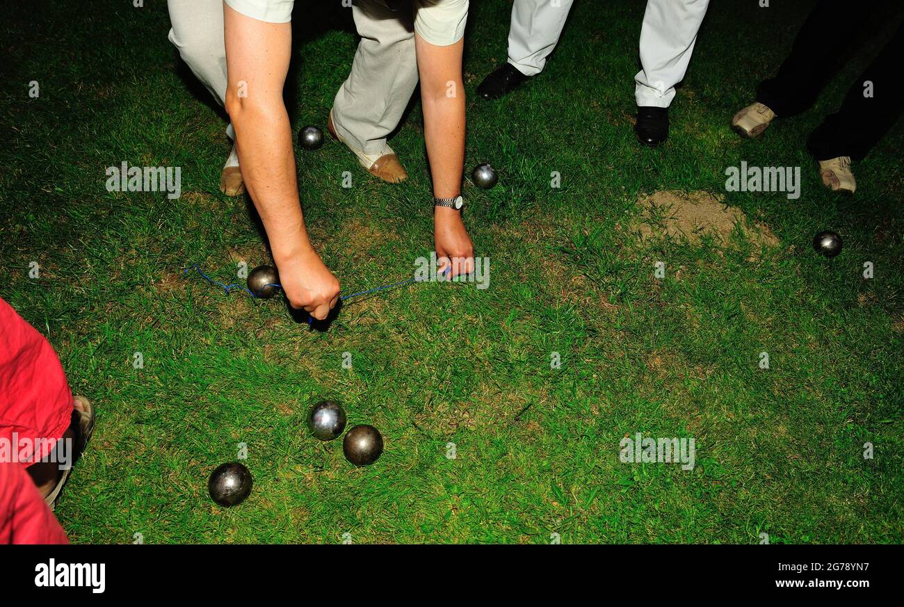 Playing petanque in the late afternoon,People playing boules, petanque ...