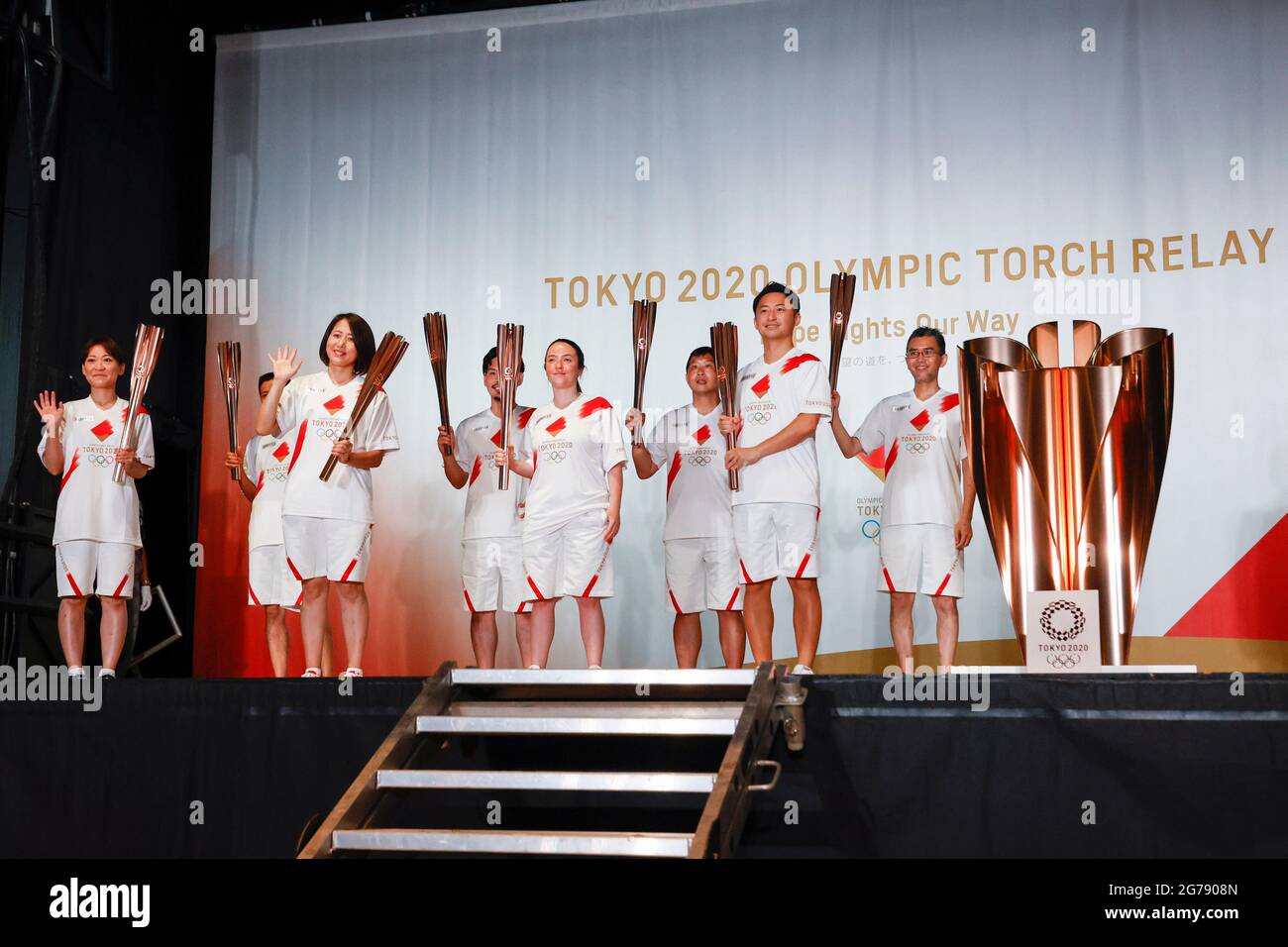 Tokyo, Japan. 12th July, 2021. Torchbearers pose for the cameras during ...