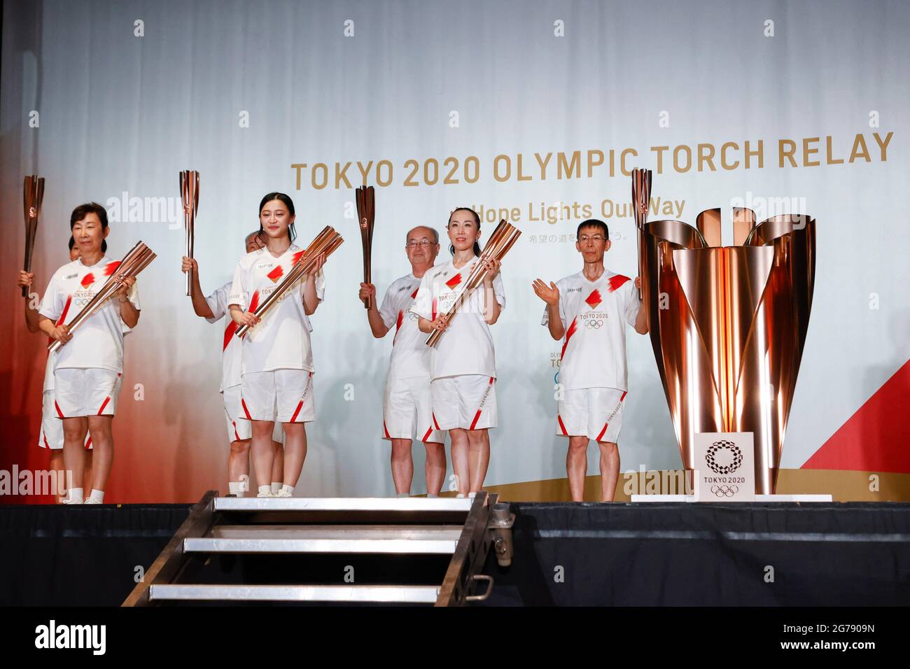 Tokyo, Japan. 12th July, 2021. Torchbearers pose for the cameras during ...