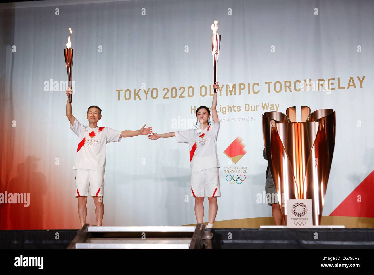 Tokyo, Japan. 12th July, 2021. Torchbearers pose for the cameras during ...