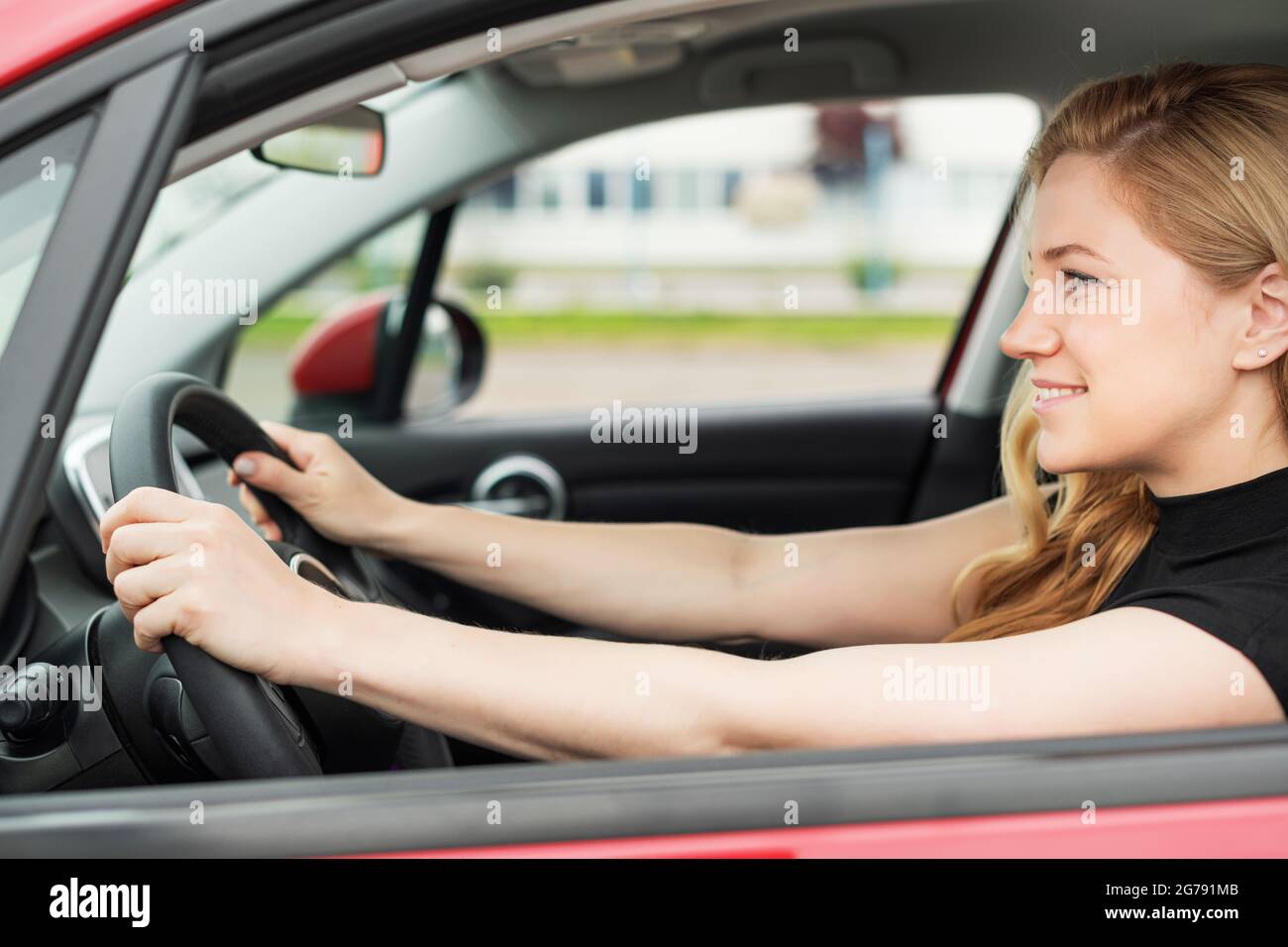 Happy beautiful woman drives a car Stock Photo - Alamy