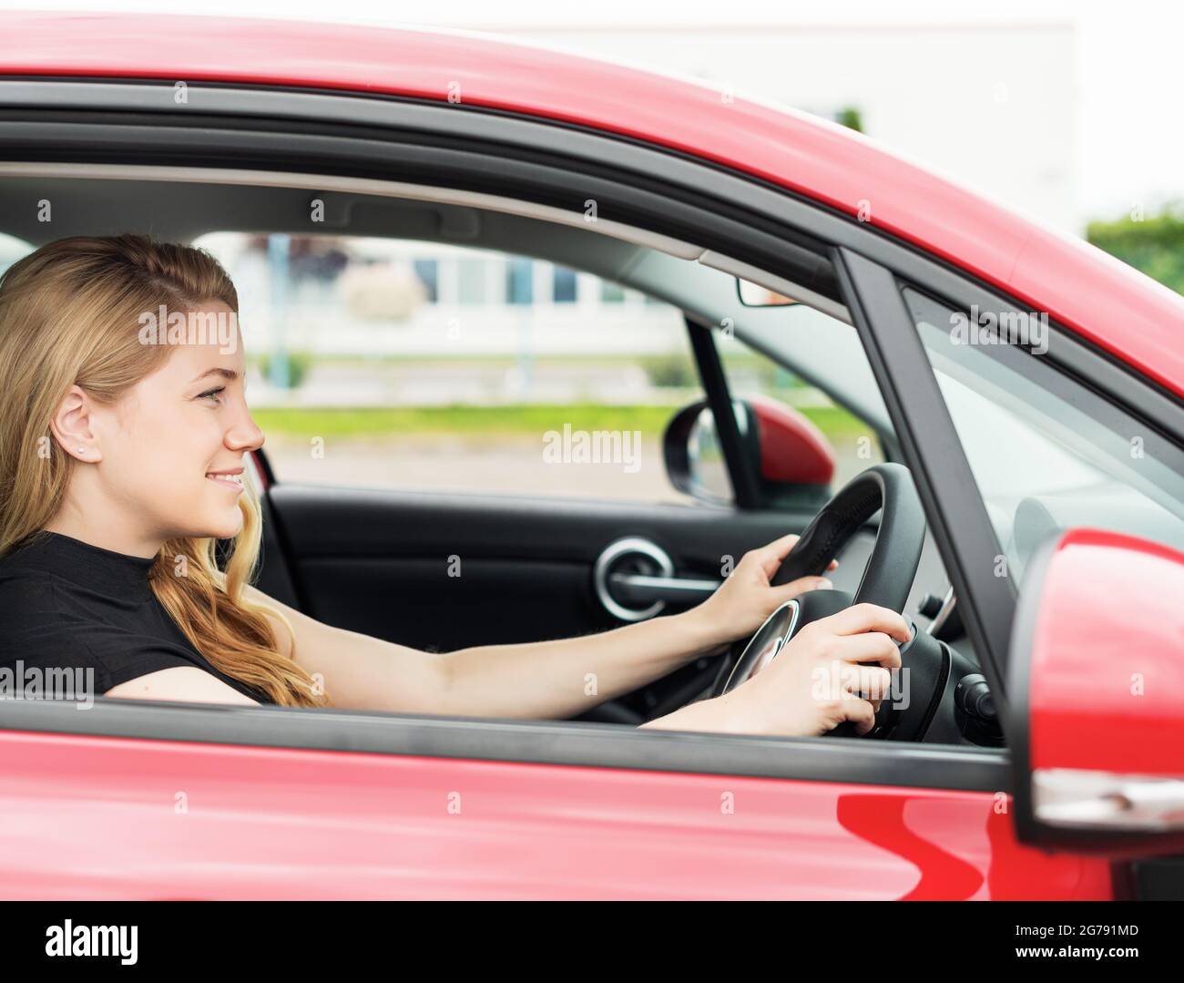 Happy beautiful woman drives a car Stock Photo - Alamy