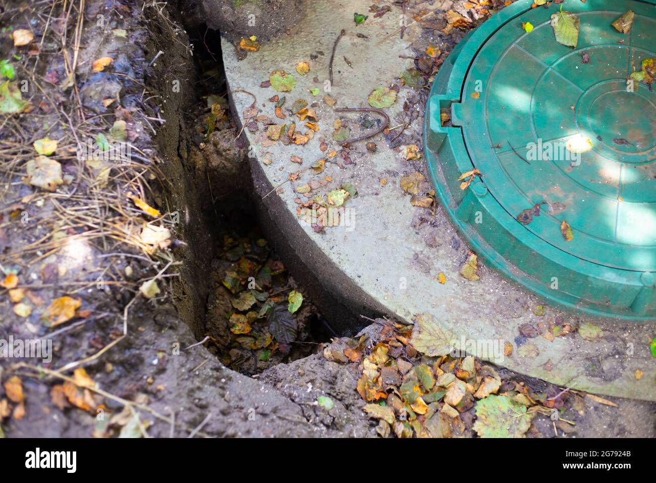Collapsed soil near the concrete rings of an underground well ...