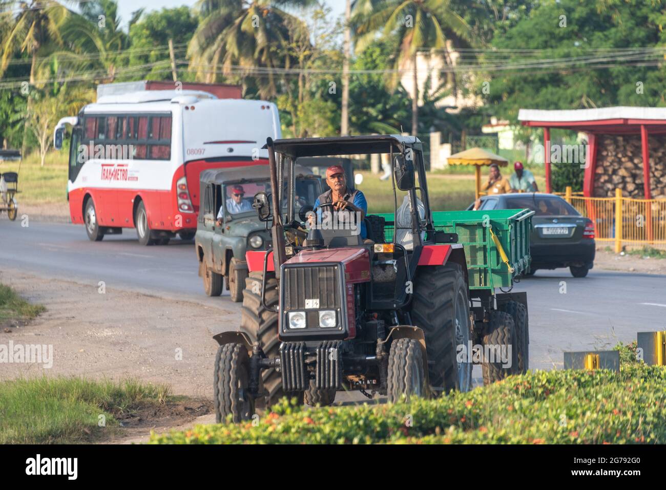 Cuban man driving an agricultural tractor on urban area, Holguin, Cuba ...