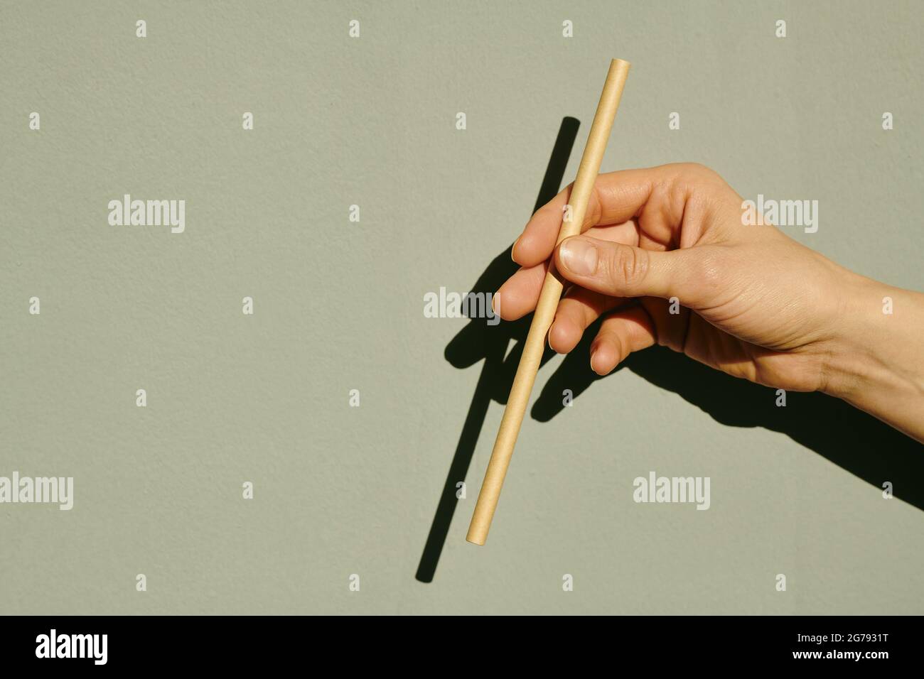 Female hand holding straw made up of eco friendly material Stock Photo ...