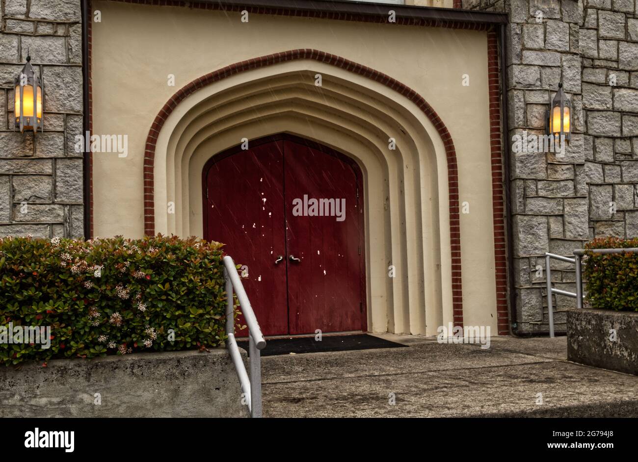 Angled view Vintage old stone wall and gothic entrance with illuminated ...