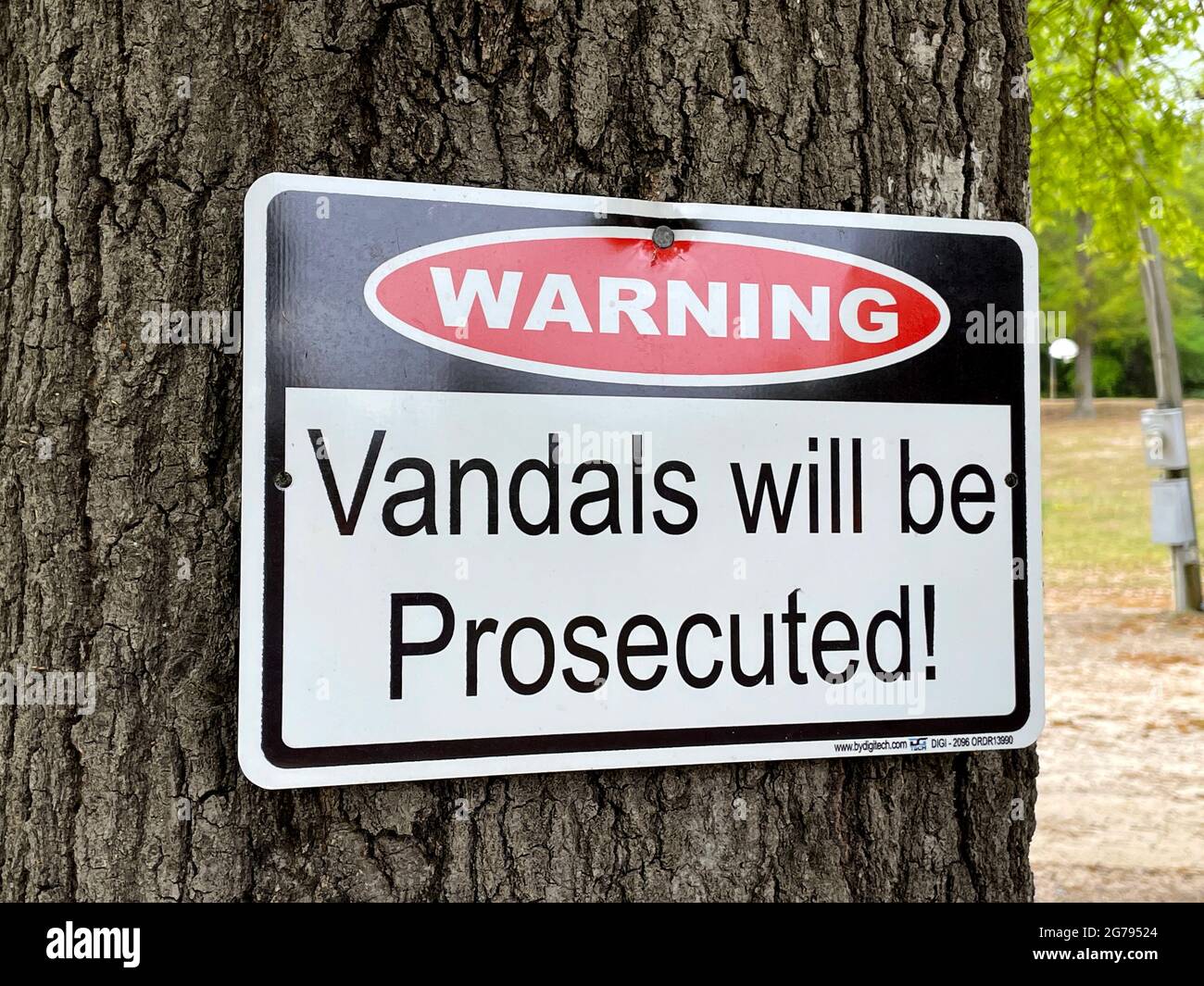 Warning Vandals will be Prosecuted sign on a tree in a park Stock Photo ...