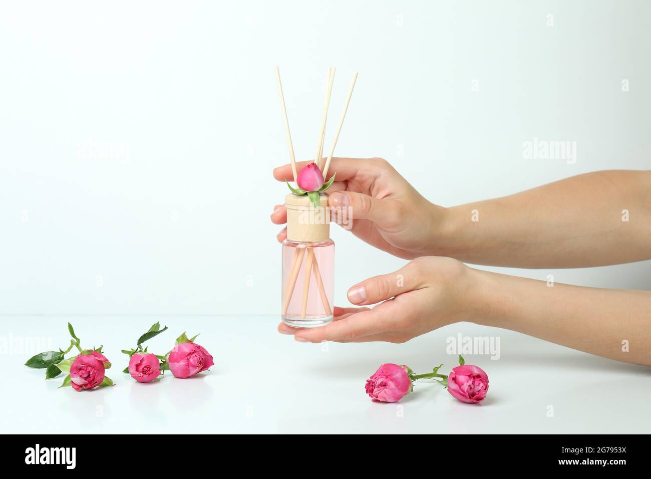 Female hands hold diffuser on white background Stock Photo - Alamy