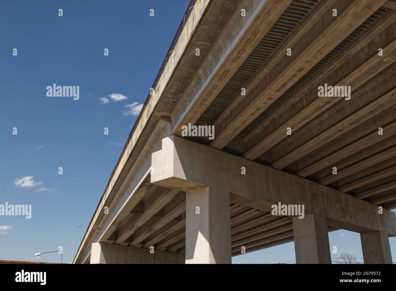 Underside of a concrete modern bridge and a blue sky background Stock ...