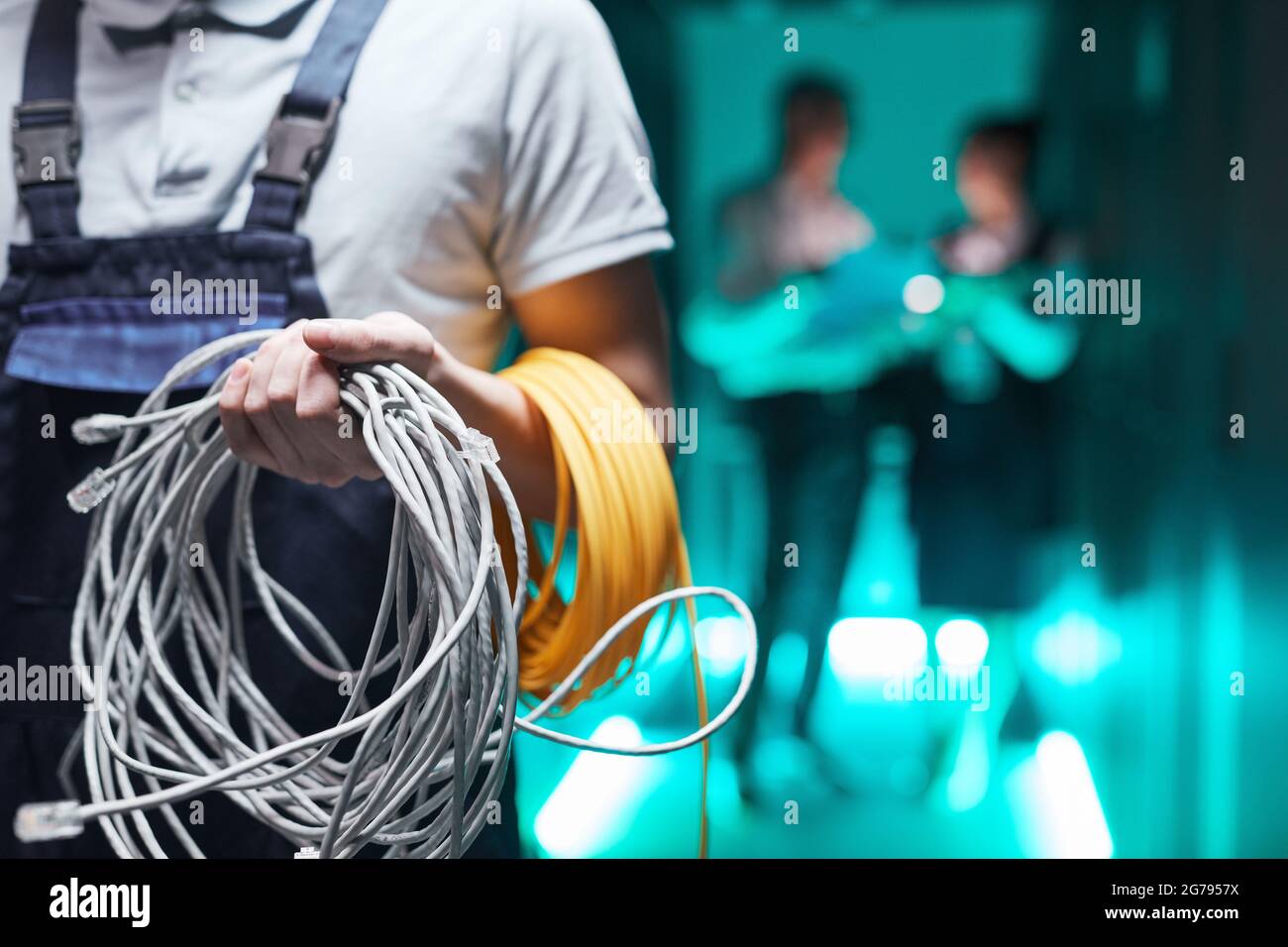 Close up of network engineer holding cables in server room during ...