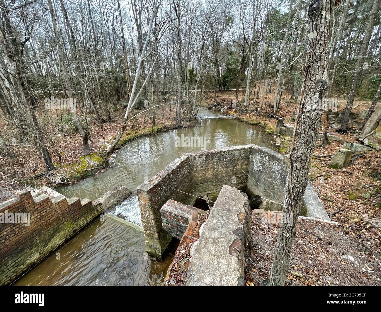 Dam with Brick ruins and river with fall foliage in a forest in rural ...