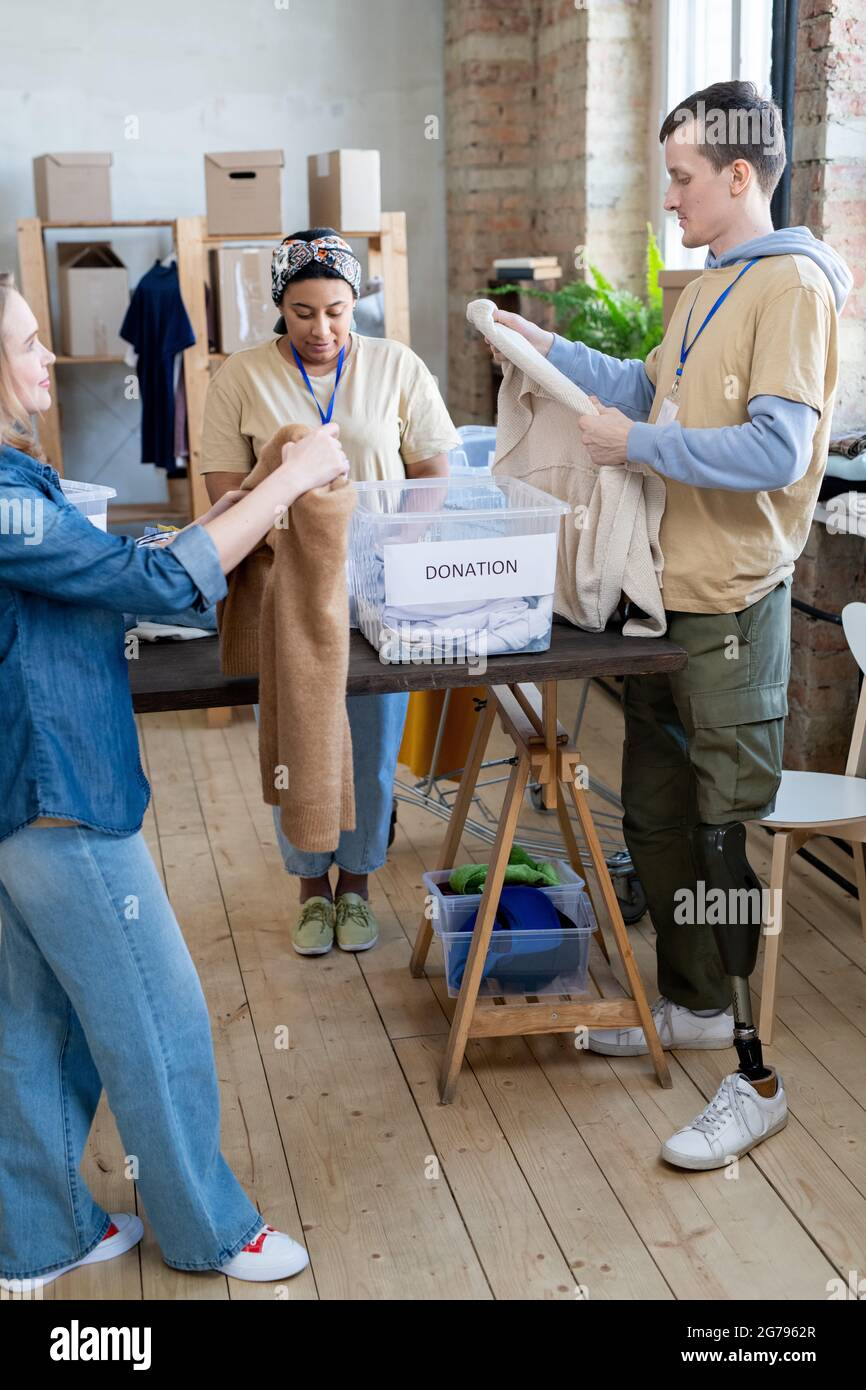 Group of young people with clothes donation Stock Photo - Alamy