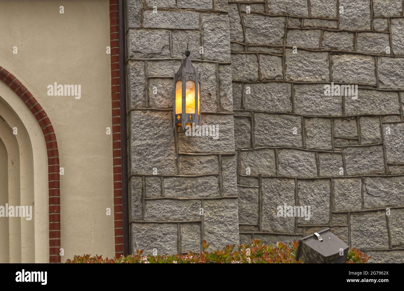Close up Vintage old stone wall and gothic entrance with illuminated ...