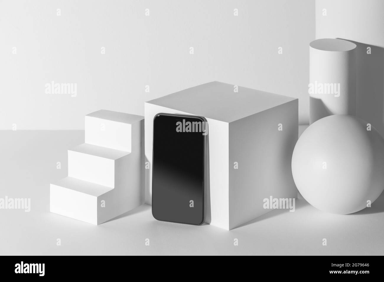 Cell phone with empty screen among white 3d paper shapes with copy ...