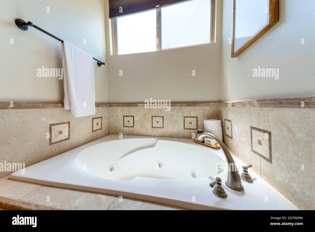 Bathtub on a deck with patterned tiles and windows Stock Photo - Alamy