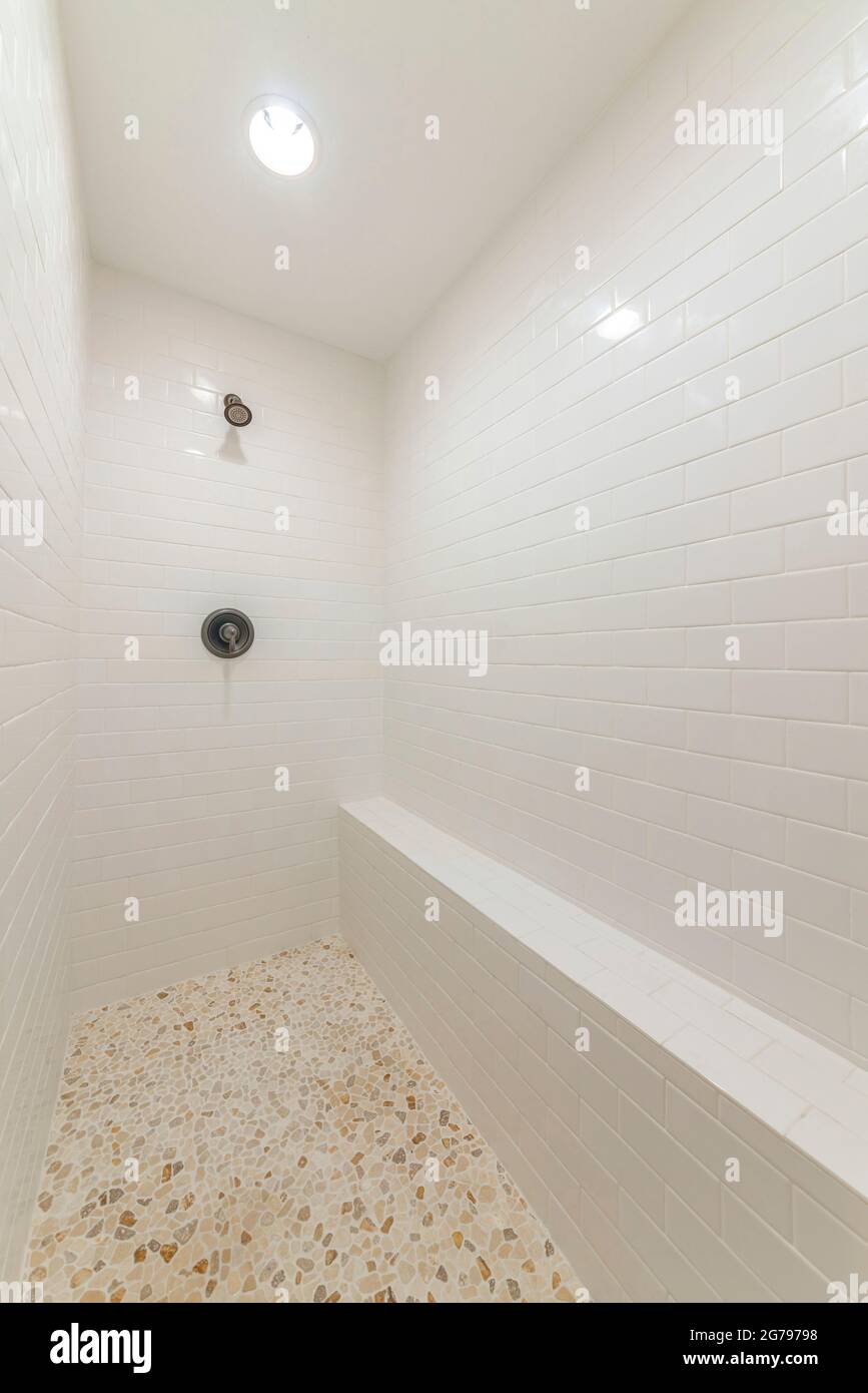 Inside a white shower room with tile flooring and walls Stock Photo - Alamy