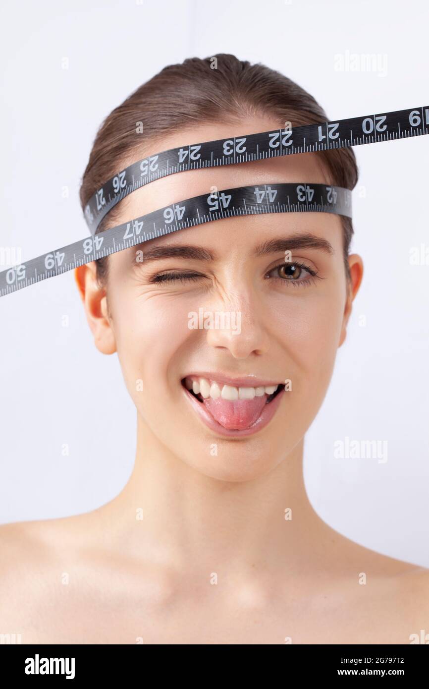 Woman with measuring tape, symbol beauty, pure skin, cosmetic surgery ...