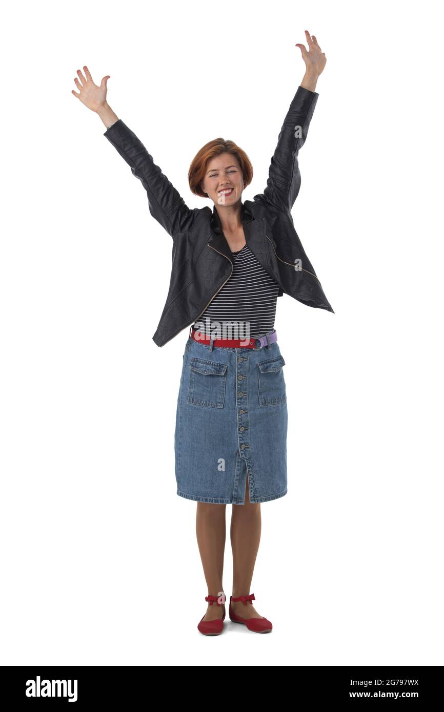 Woman raises her arms overhead in joy isolated on white background ...