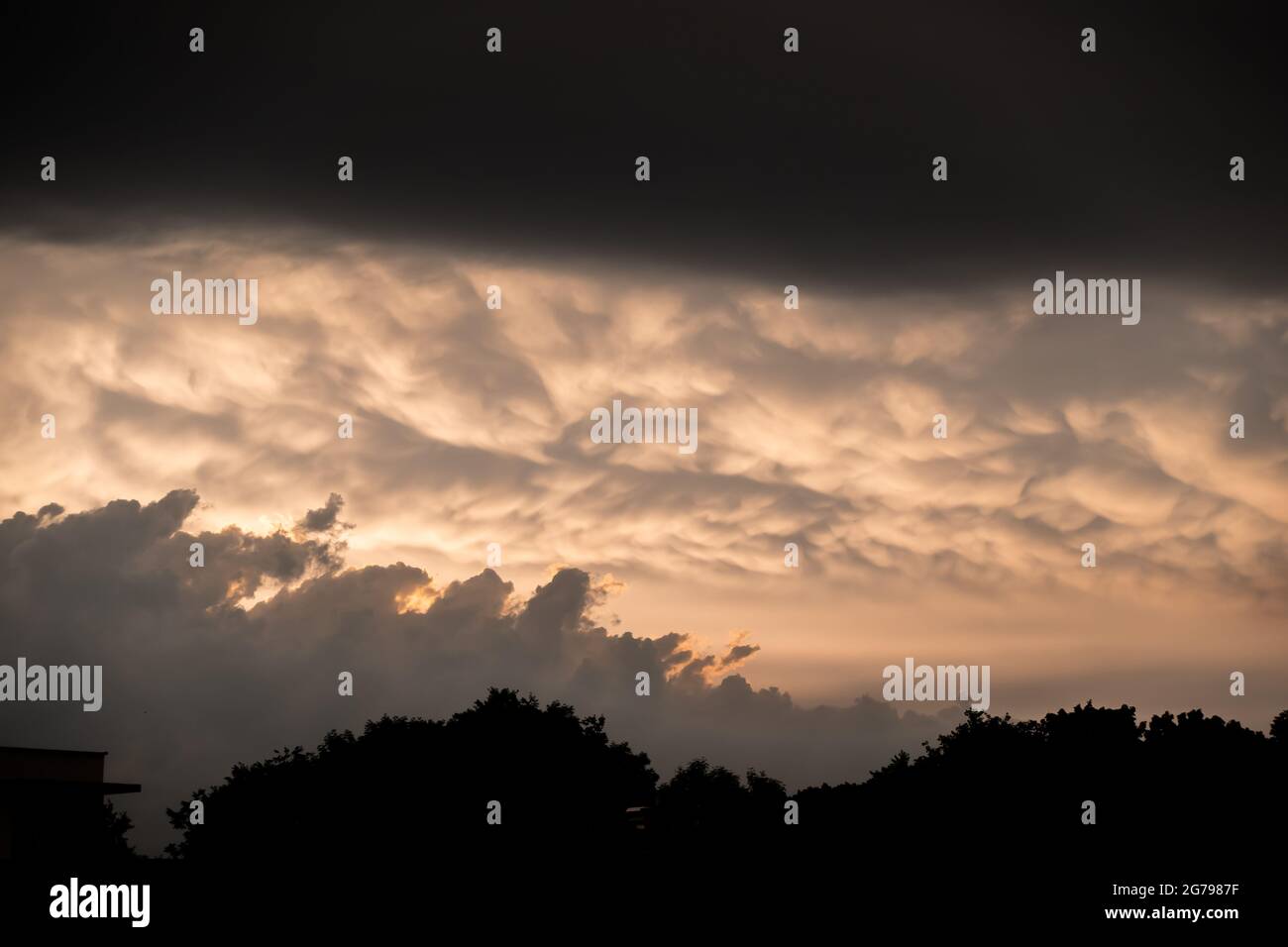 Dramatic yellow cloudy sky before the evening storm. Photo taken in low ...