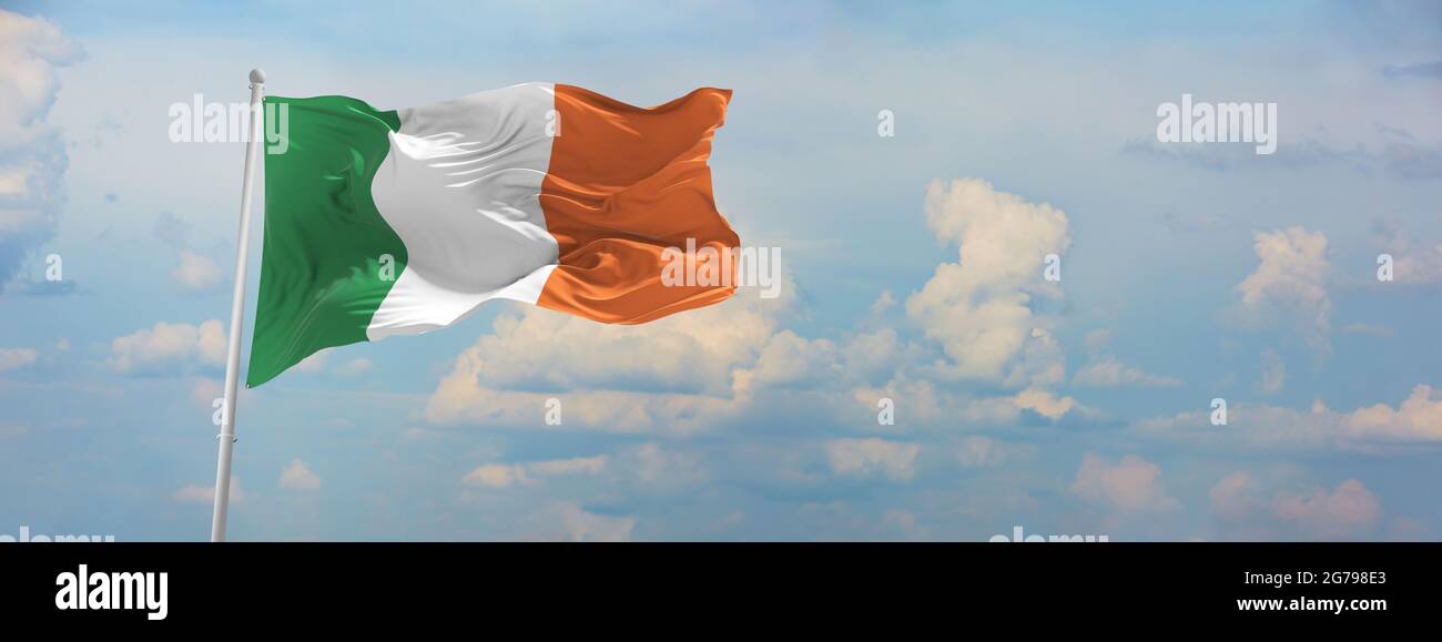 flag of Ireland at cloudy sky background on sunset, panoramic view ...